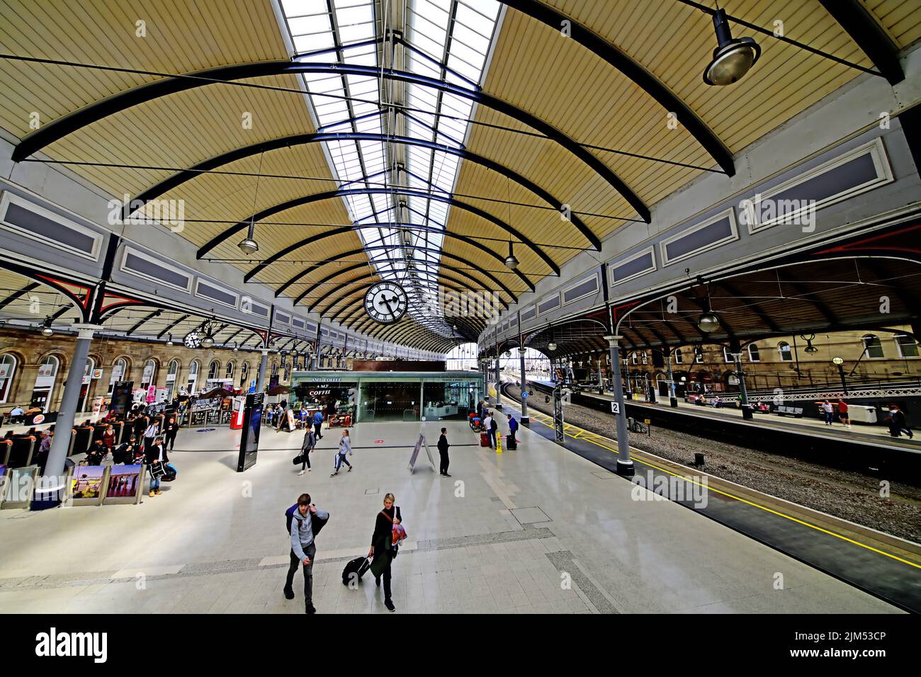 Newcastle Central Rail Station platforms amid cafes with the passengers ...