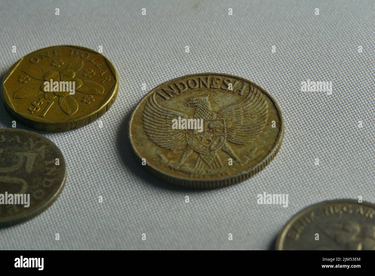 Closeup of coins of the Republic of Indonesia on a white background ...