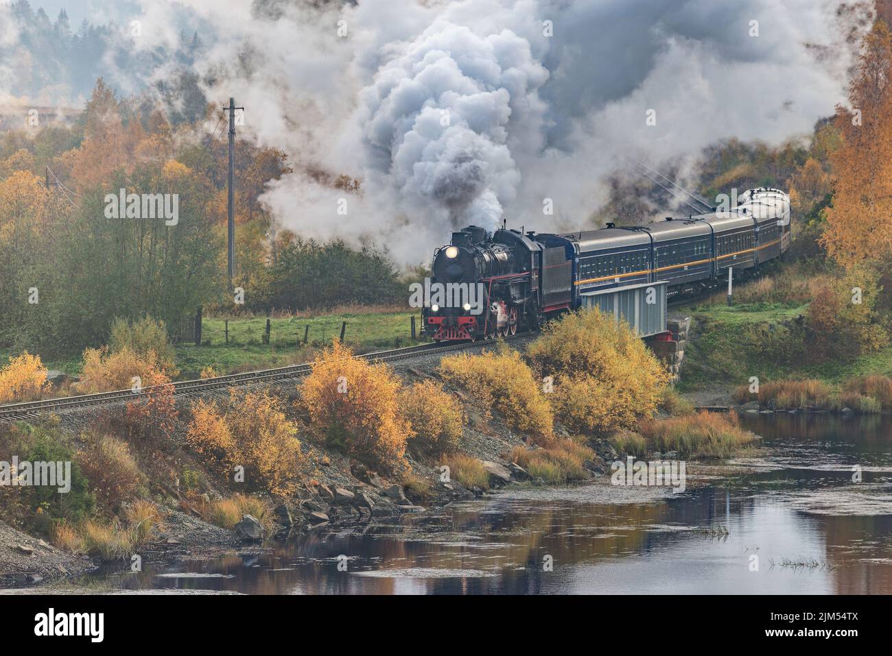 Retro steam train at autumn cloudy morning Stock Photo - Alamy