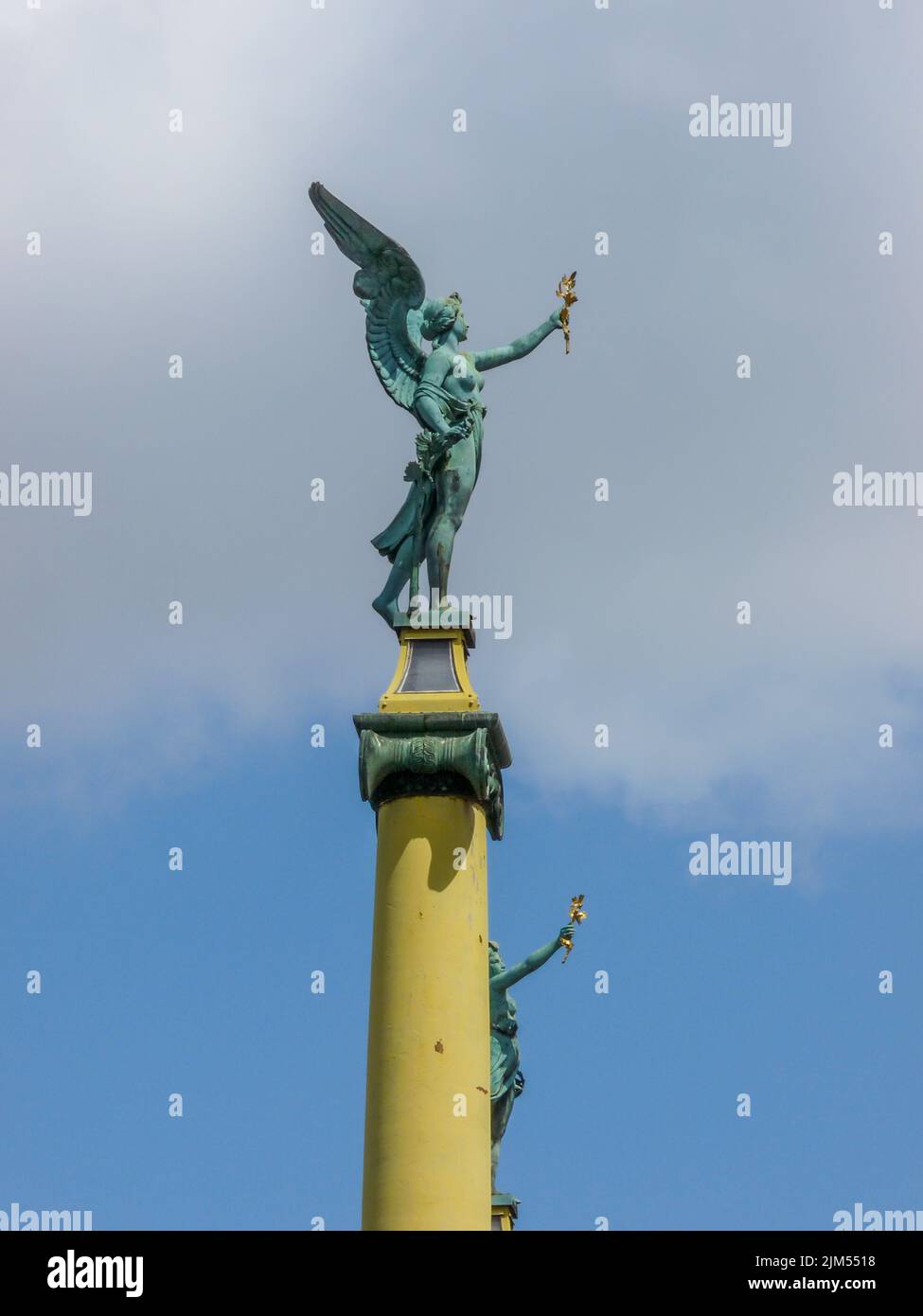 A statue of an angel with wings at the top of a column on the Cech ...