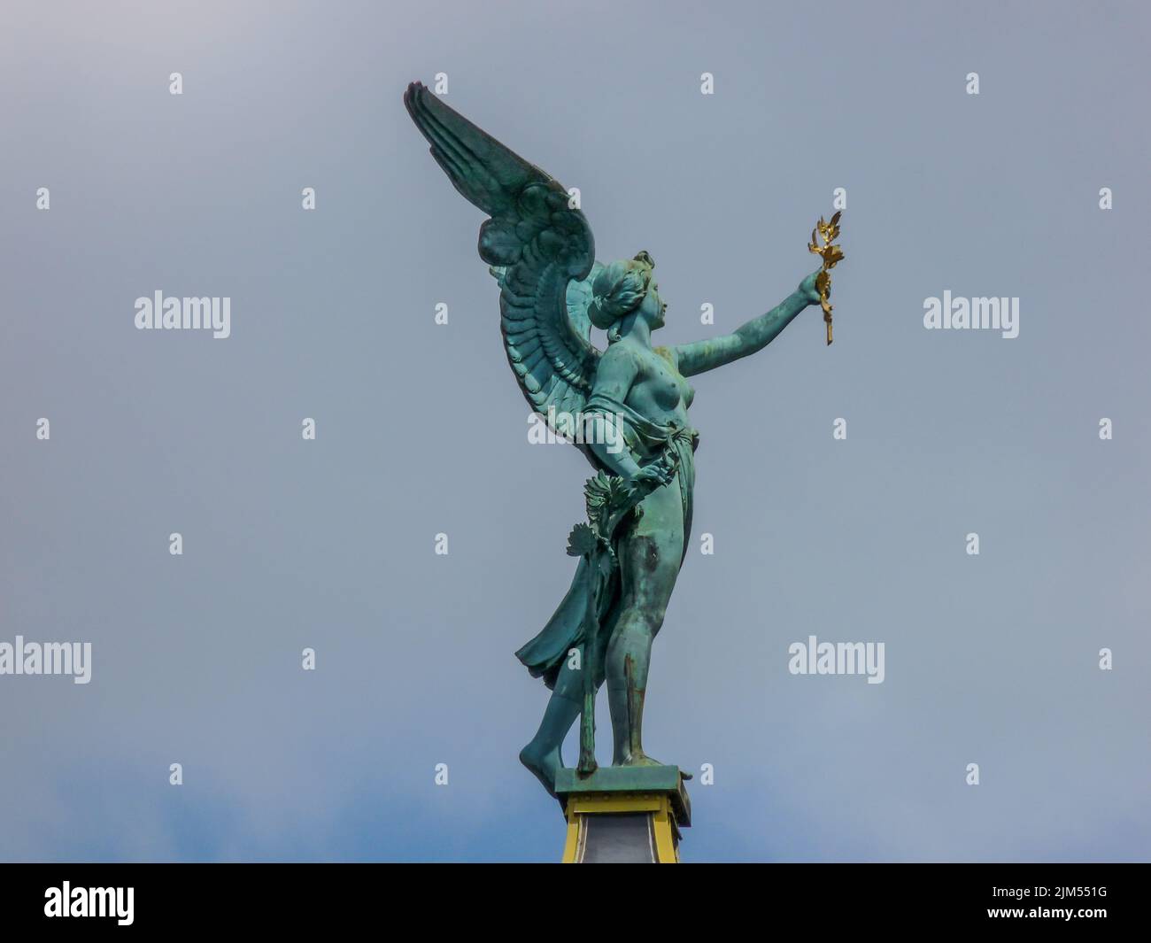 A statue of an angel with wings at the top of a column on the Cech ...