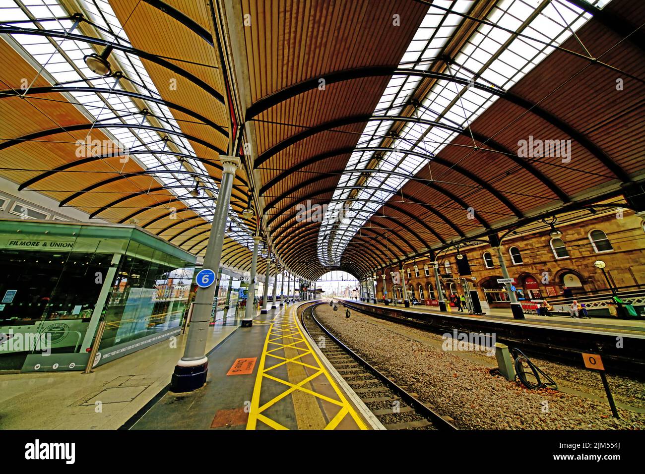 Newcastle Central Rail Station platforms amid cafes with the passengers ...