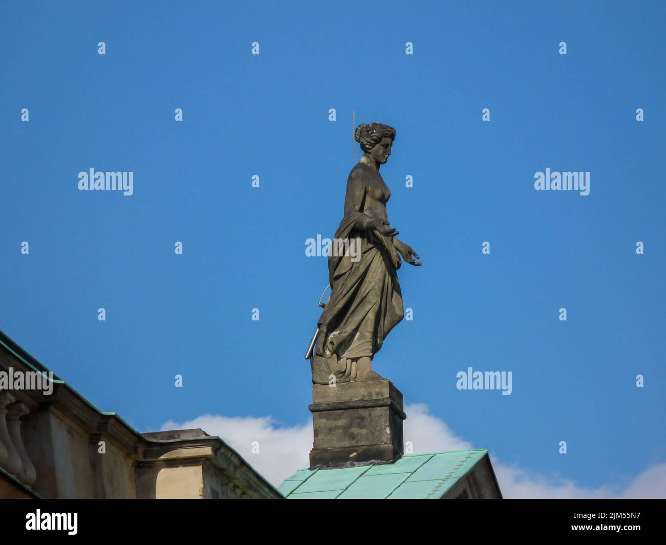 A scenic view of an old statue depicting a woman in blue sky background ...