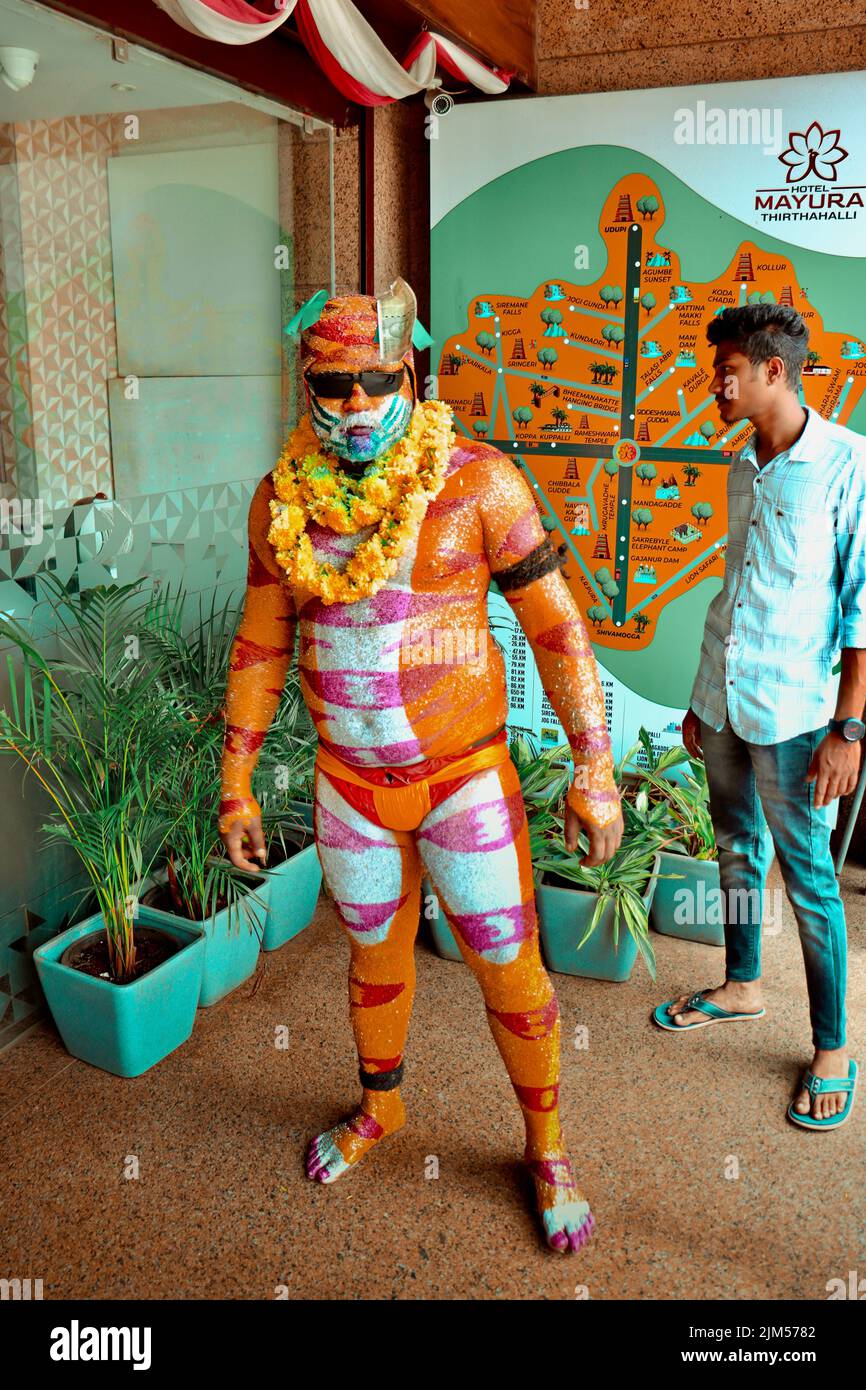 A man body painted with tiger design or pattern dancing on the occasion ...