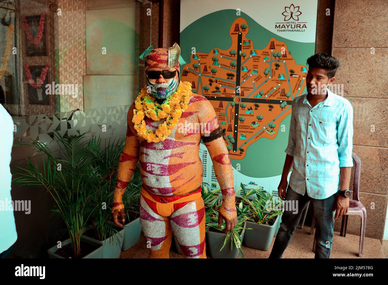 A man body painted with tiger design or pattern dancing on the occasion ...