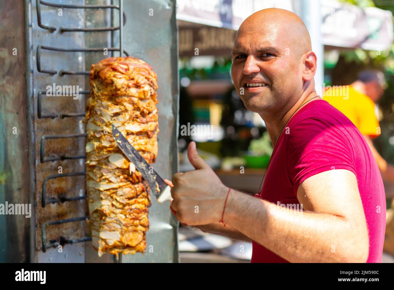 Chef cutting with doner knife Traditional Turkish Doner Kebab meat and ...