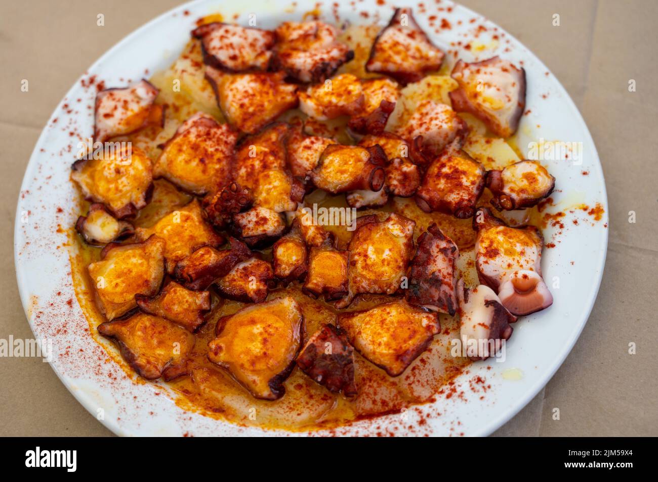 Tasty seafood, grilled octopus galician style with red pimento paprika ...
