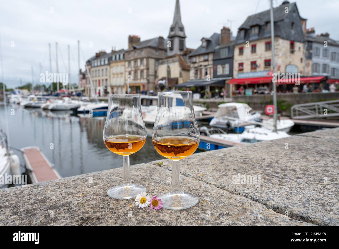 Tasting of apple calvados drink from glasses in old Honfleur harbour ...
