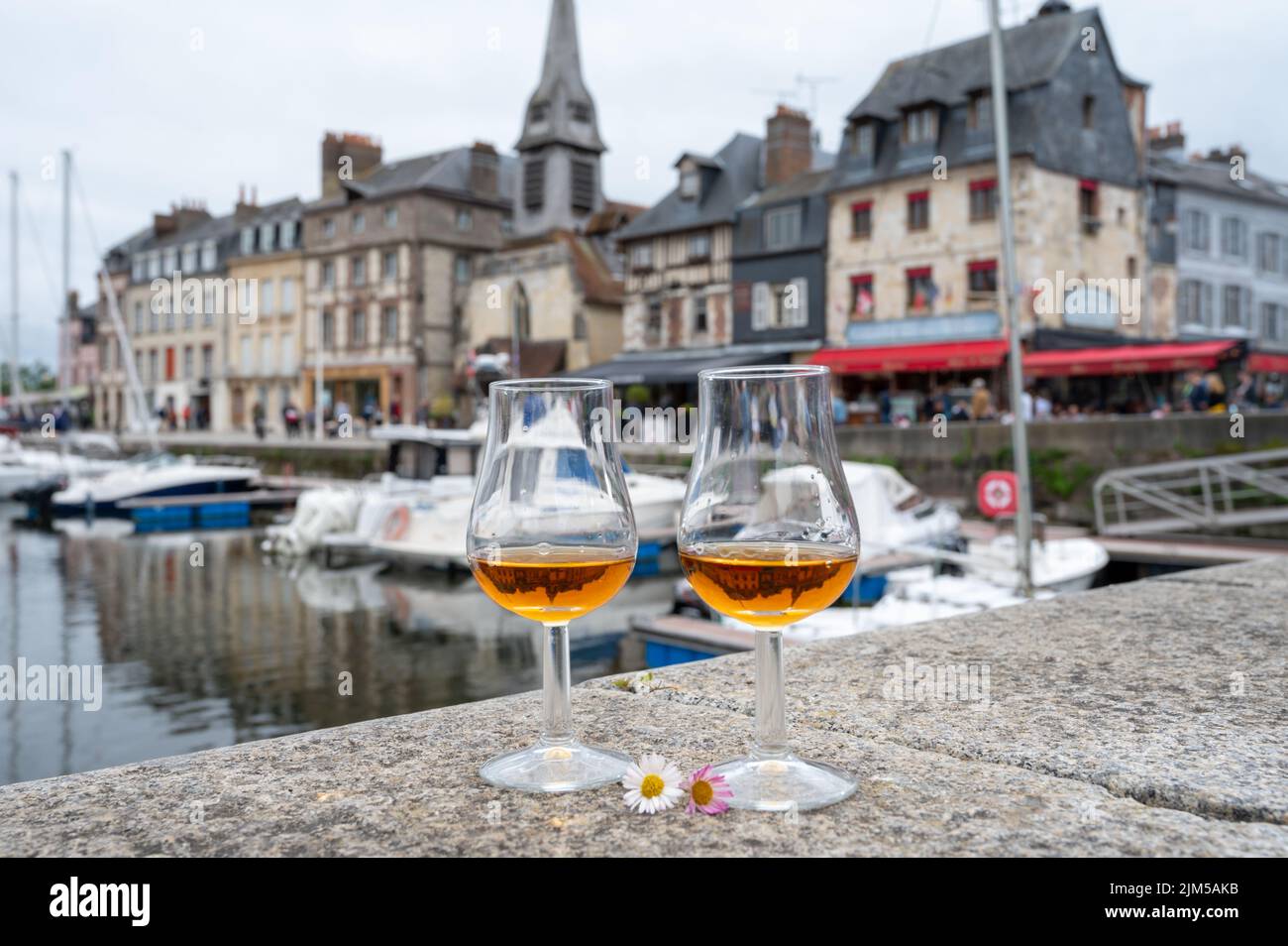 Tasting of apple calvados drink from glasses in old Honfleur harbour ...