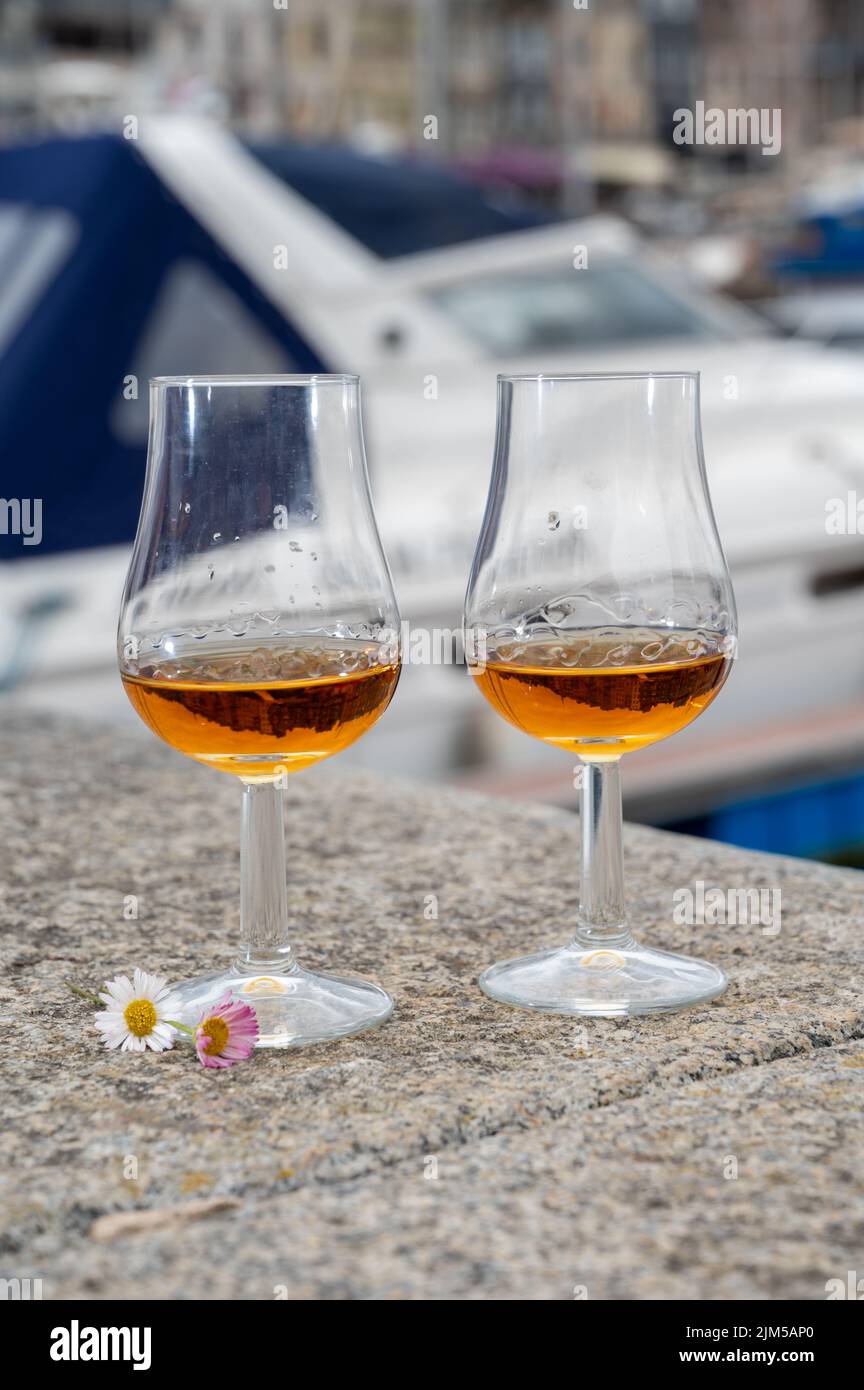 Tasting of apple calvados drink from glasses in old Honfleur harbour ...