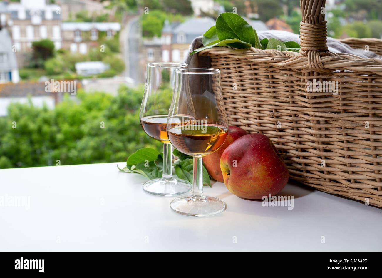 Tasting of strong alcoholic drink calvados made from apples in Normandy ...