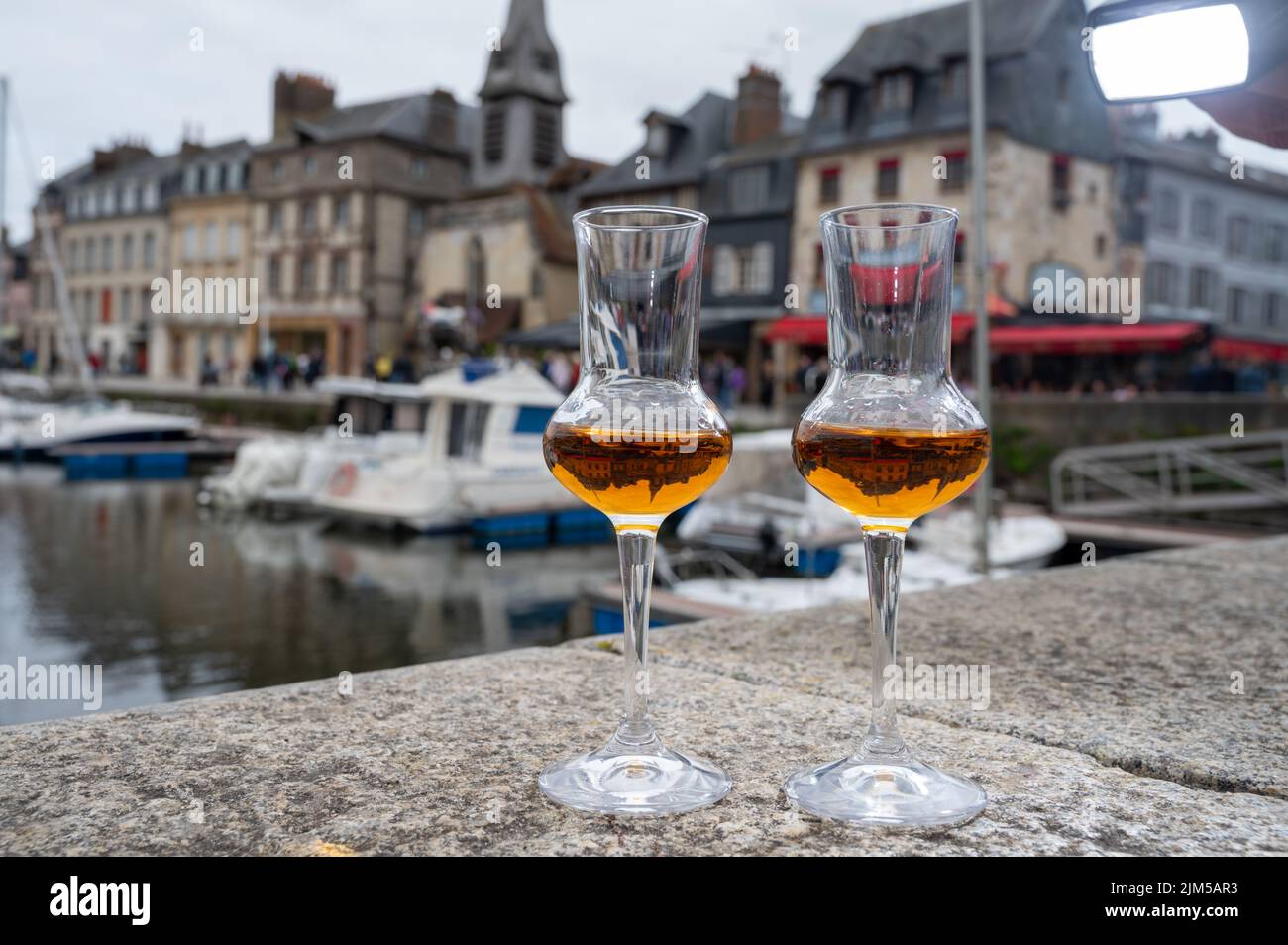 Tasting of apple calvados drink from glasses in old Honfleur harbour ...