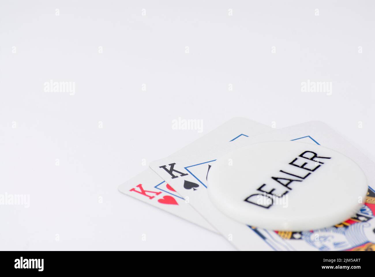 Two king cards and a dealer chip on a white background Stock Photo - Alamy