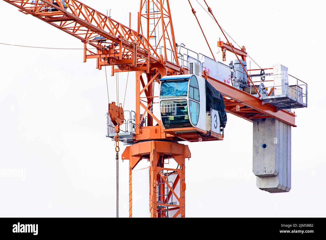 A tall orange crane on an industrial construction site Stock Photo - Alamy