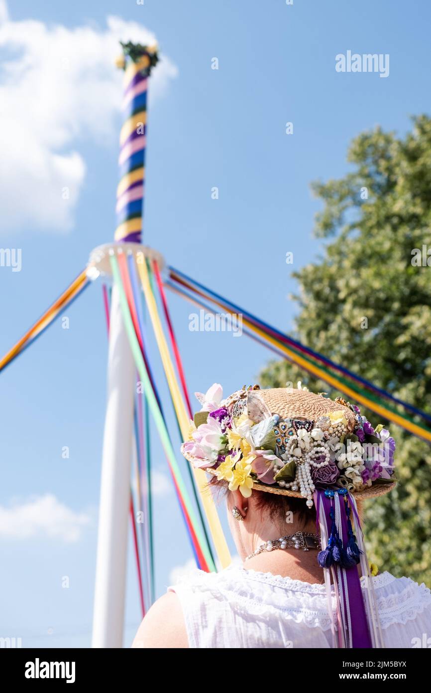 A vertical shot of a traditional English Maypole dancer with a floral ...