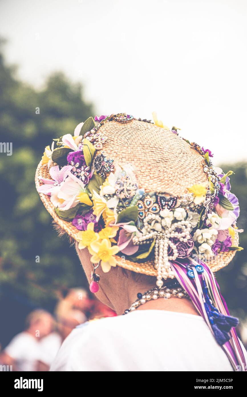 A vertical shot of a traditional English Maypole dancer with a floral ...