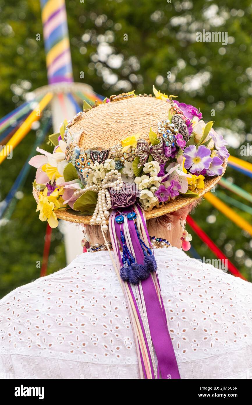 A vertical shot of a traditional English Maypole dancer with a floral ...