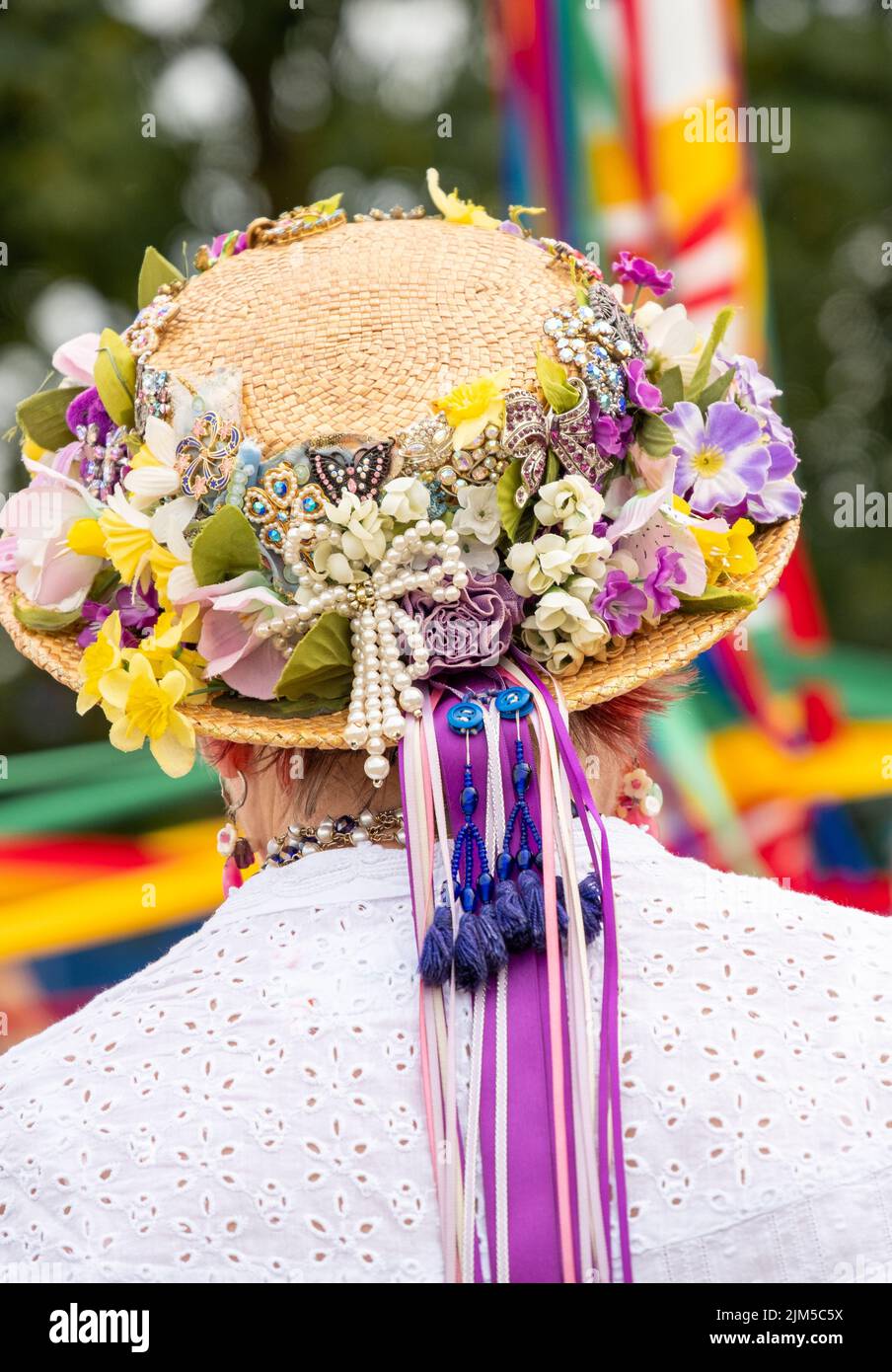 A vertical shot of a traditional English Maypole dancer with a floral ...