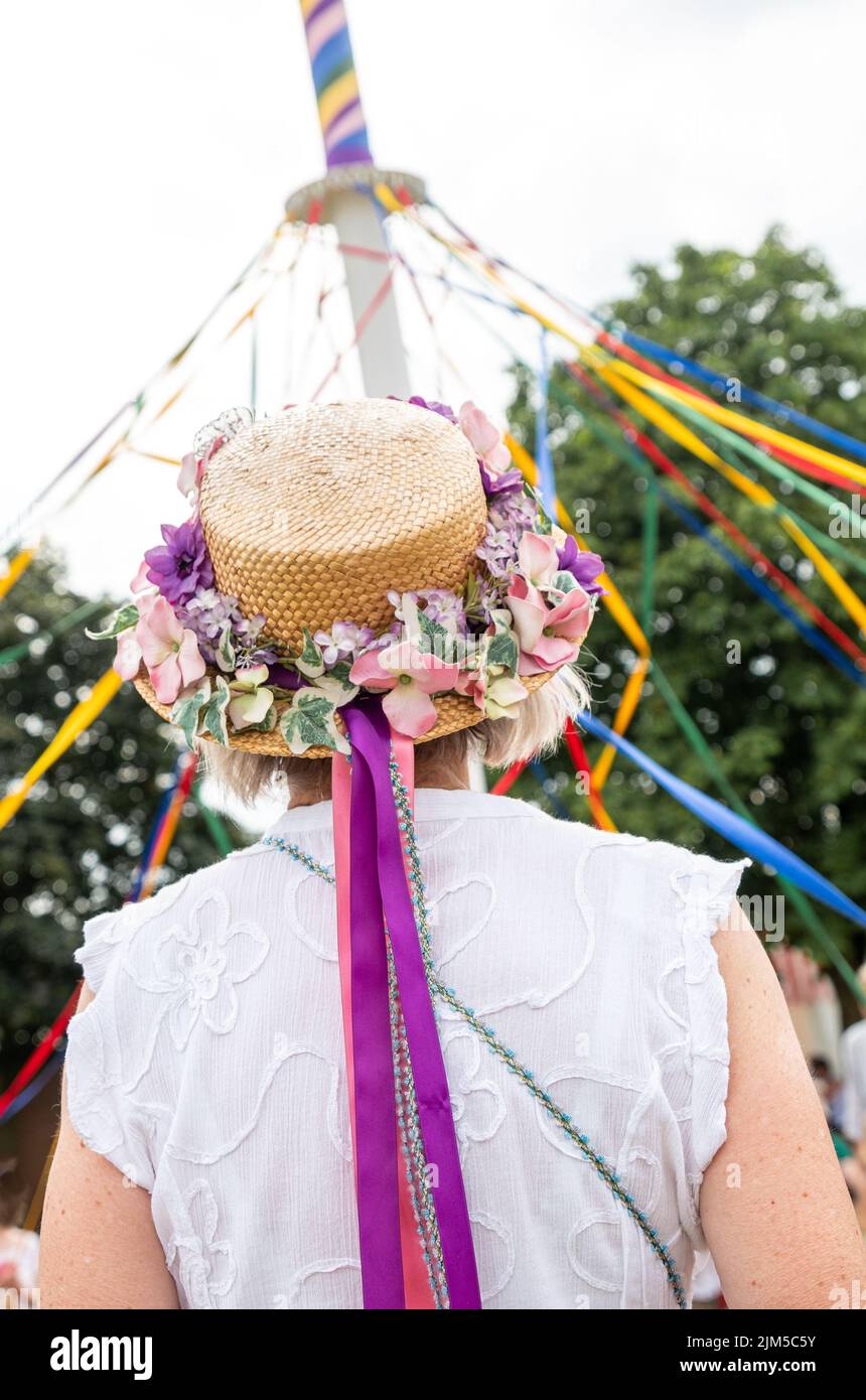 A vertical shot of a traditional English Maypole dancer with a floral ...