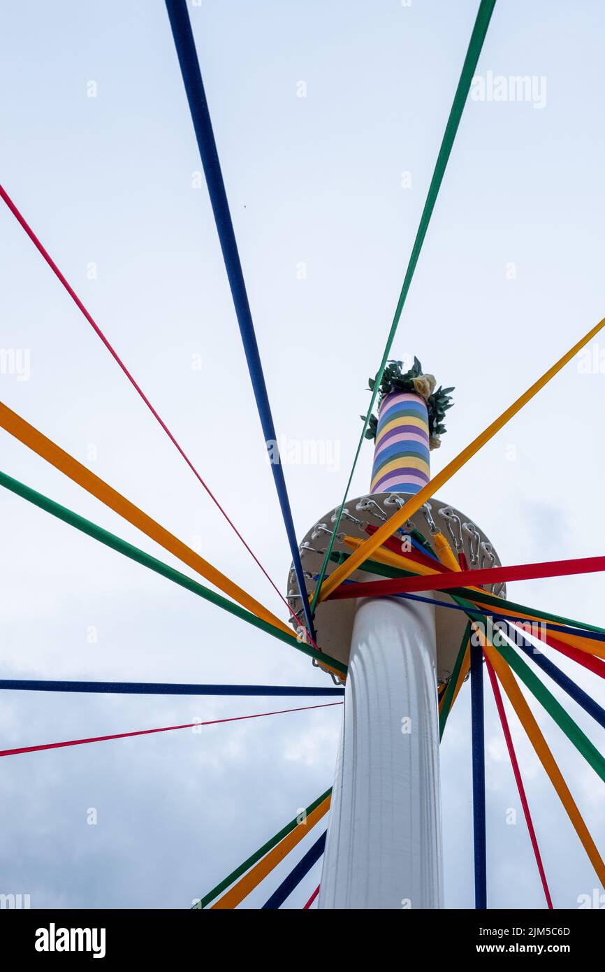 A low angle shot of a pole with colored ribbons on a traditional ...