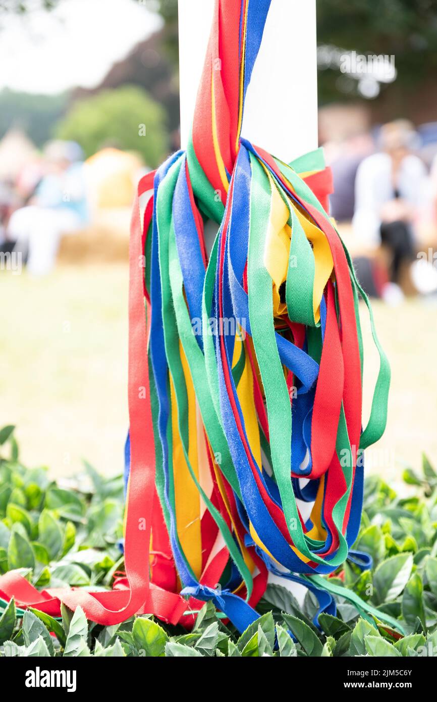 The colored ribbons hanging from the pole on a traditional English ...