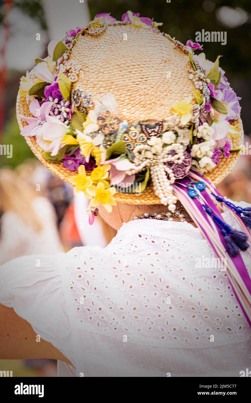A vertical shot of a traditional English Maypole dancer with a floral ...