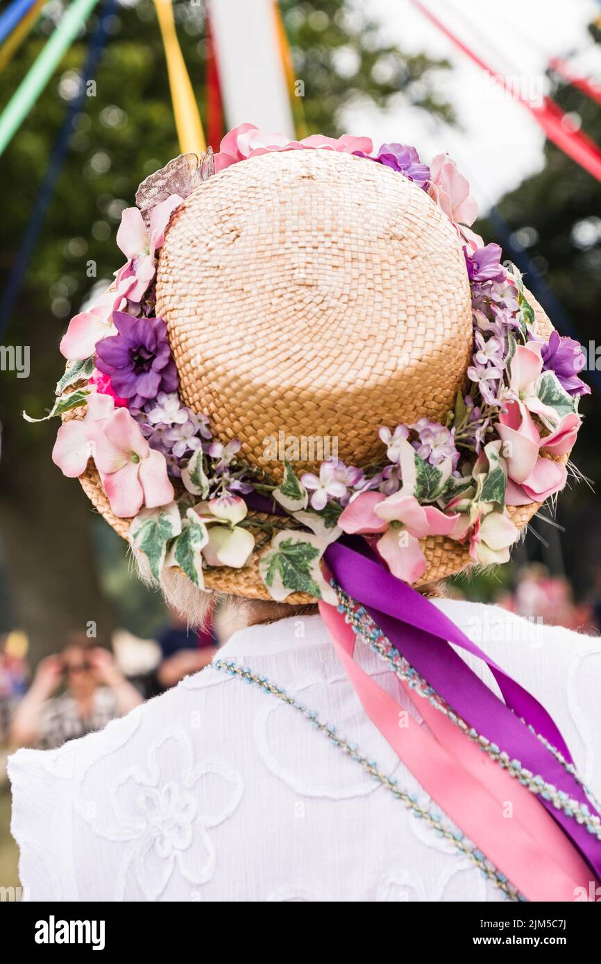 A vertical shot of a traditional English Maypole dancer with a floral ...