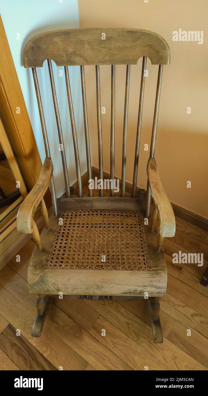 detail of an antique style wooden rocking chair used by grandmothers ...