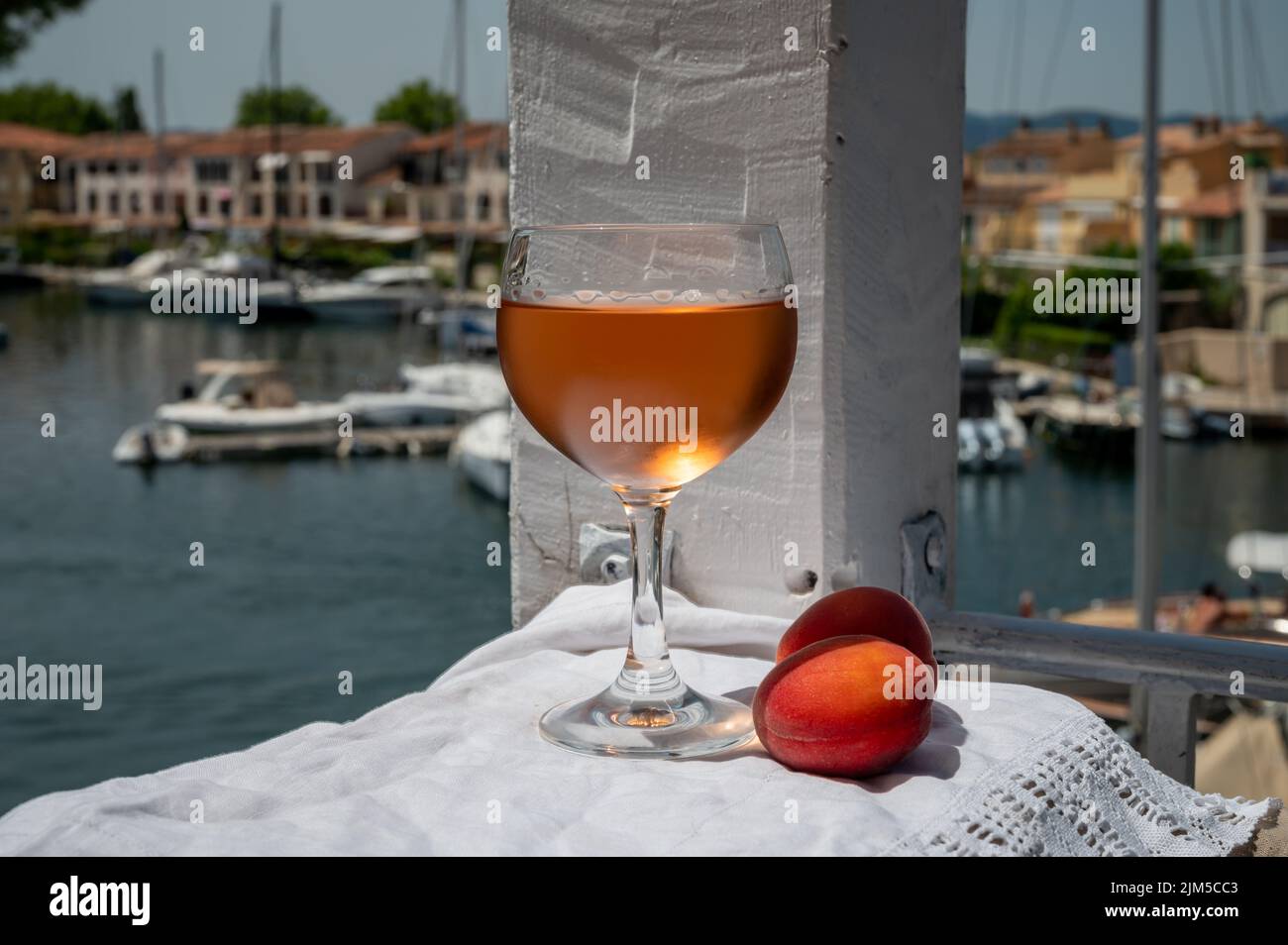 Drinking of cold rose wine from Provence with red apricots and view on ...