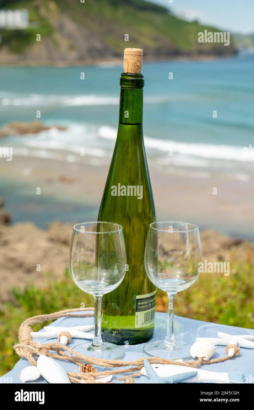 Tasting of txakoli or chacolí slightly sparkling very dry white wine ...