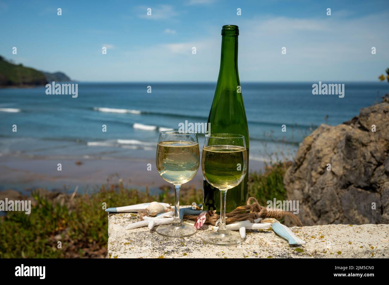Tasting of txakoli or chacolí slightly sparkling very dry white wine ...