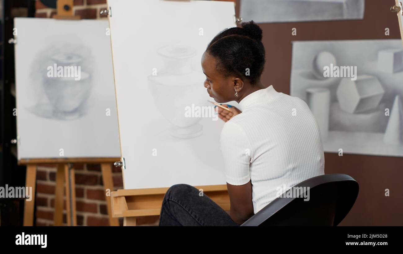 Young woman learning to draw vase sketch on paper, attending art school ...