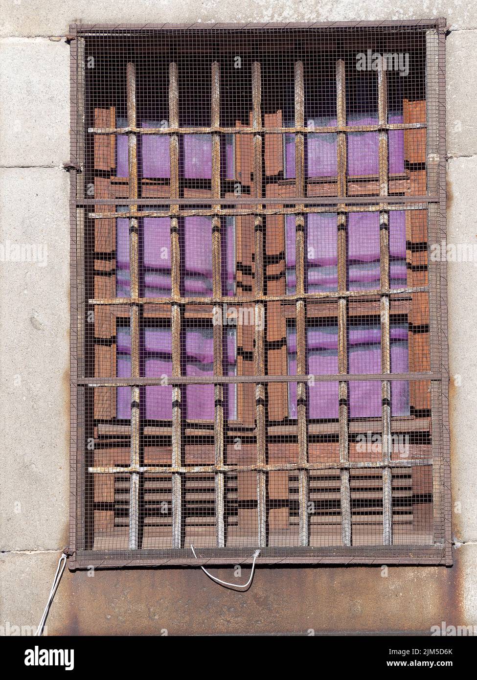 A vertical closeup of the old, rusty window bars under sunlight Stock ...