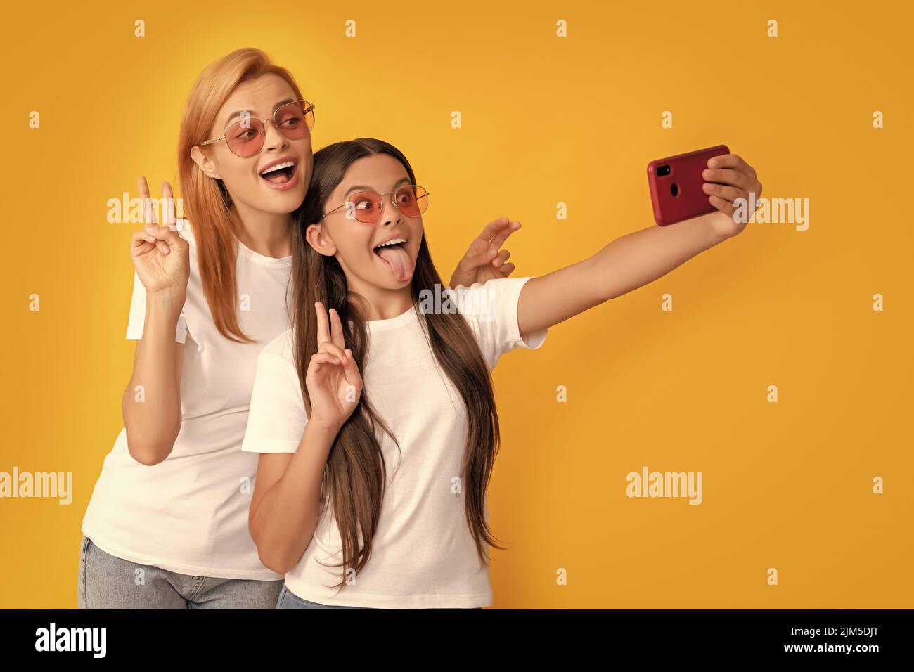 happy woman and girl take selfie with smartphone. selfie family. modern ...