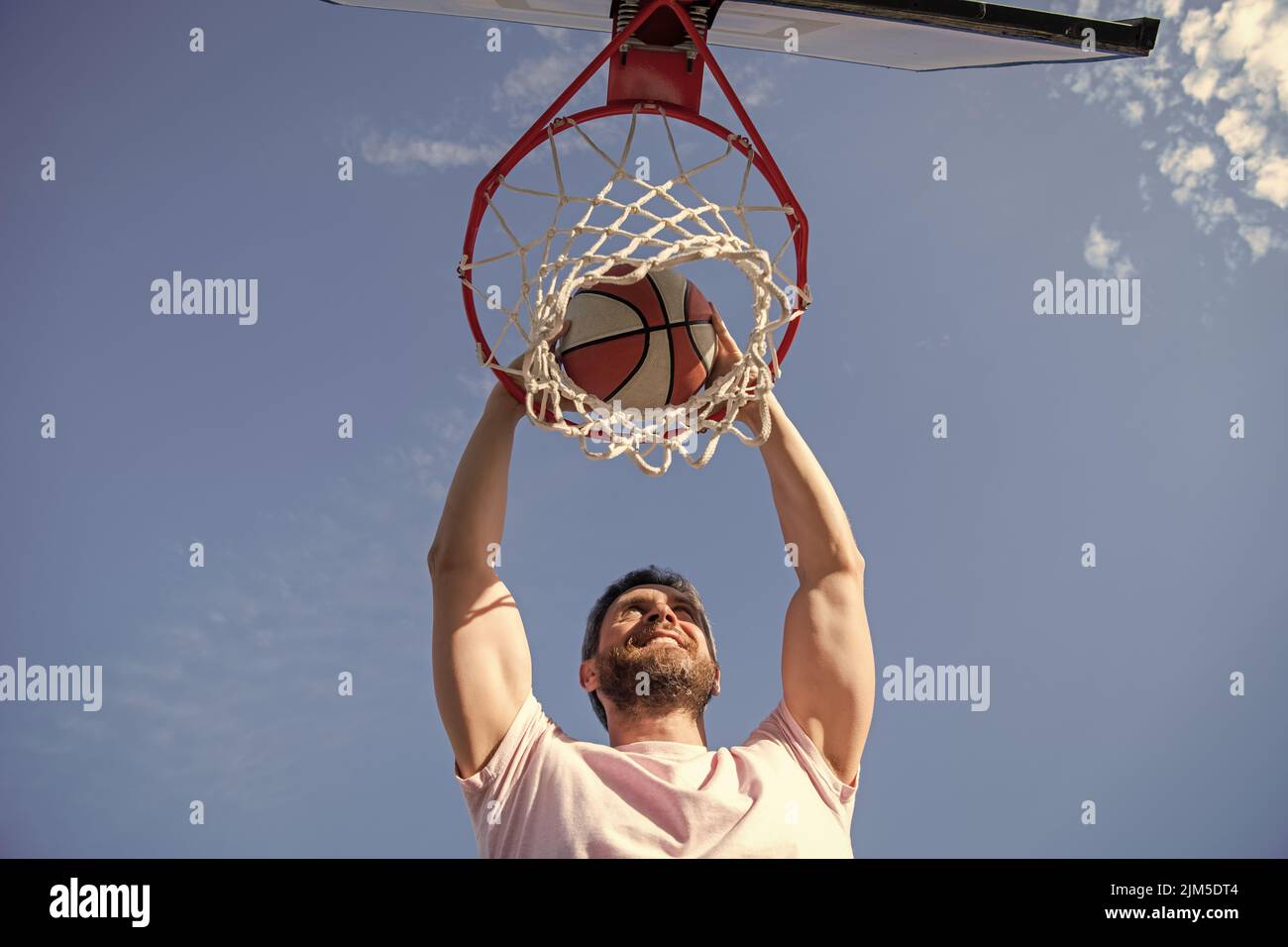 high view of basketball player throws the ball into the hoop outdoor ...