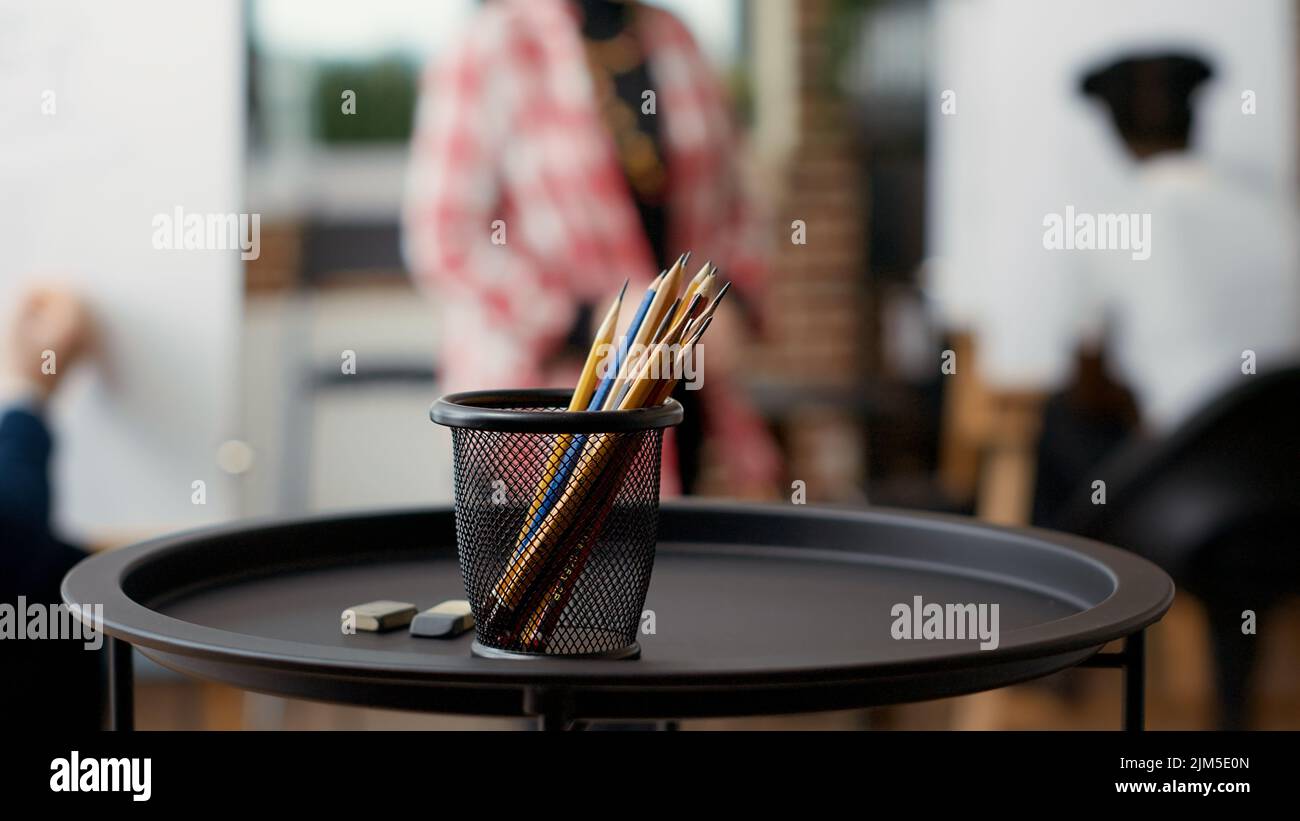 Artistic tools and colorful pencils on table in art class workshop ...
