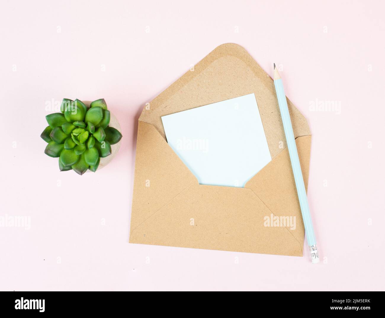 Envelope with an empty paper on a pastel colored background, copy space ...