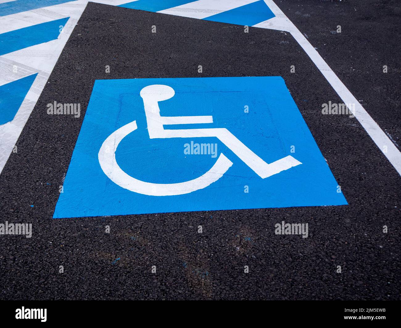 A parking lot with painted handicapped symbol of wheelchair on the ...