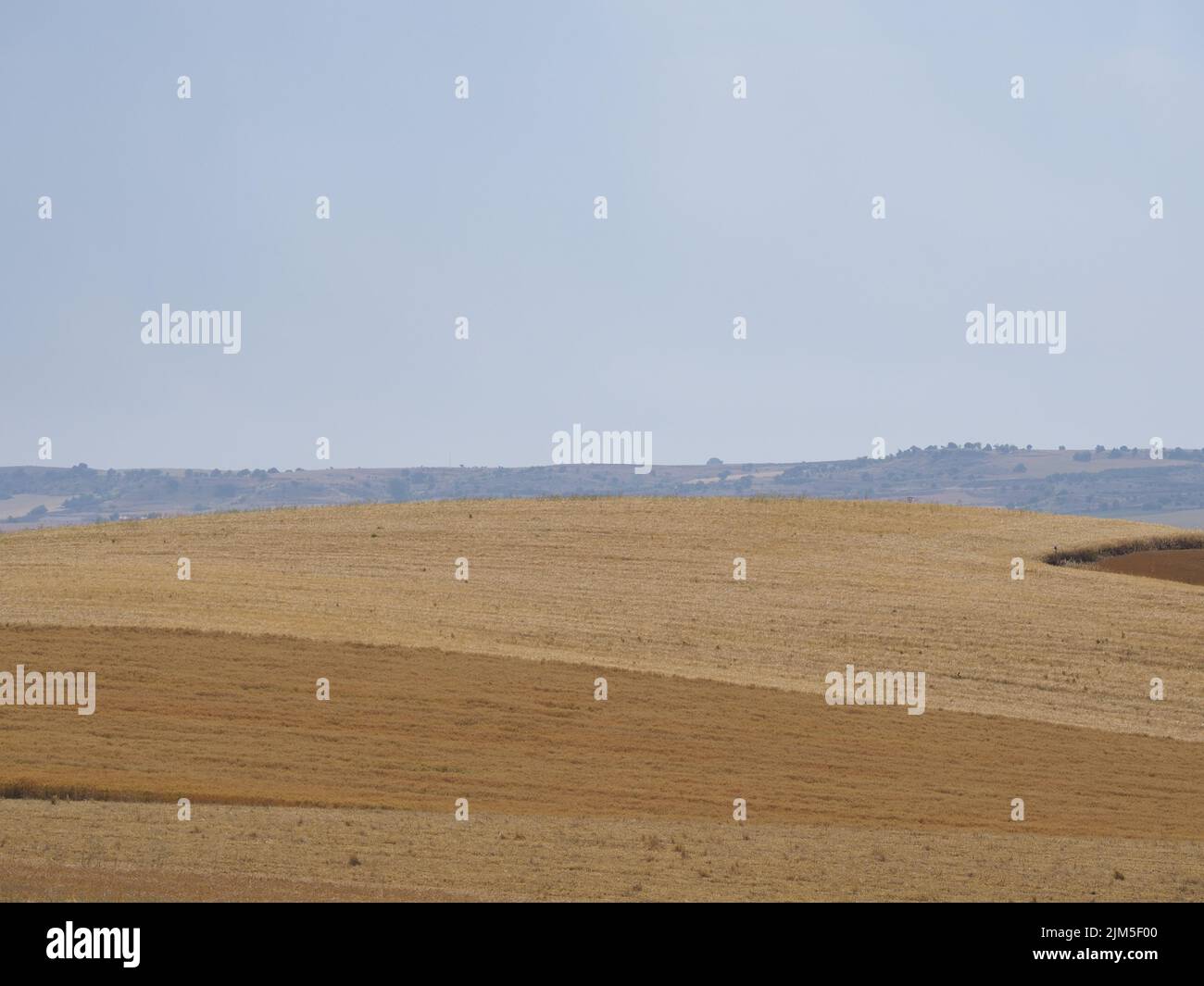 A beautiful shot of a large empty field, freshly ploughed and tilled ...