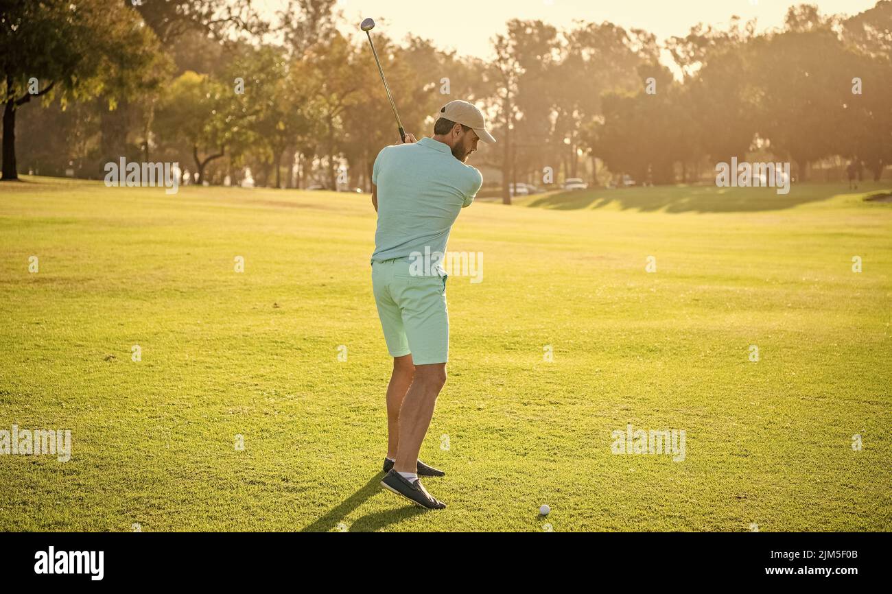 back view of male golf player on professional course with green grass ...