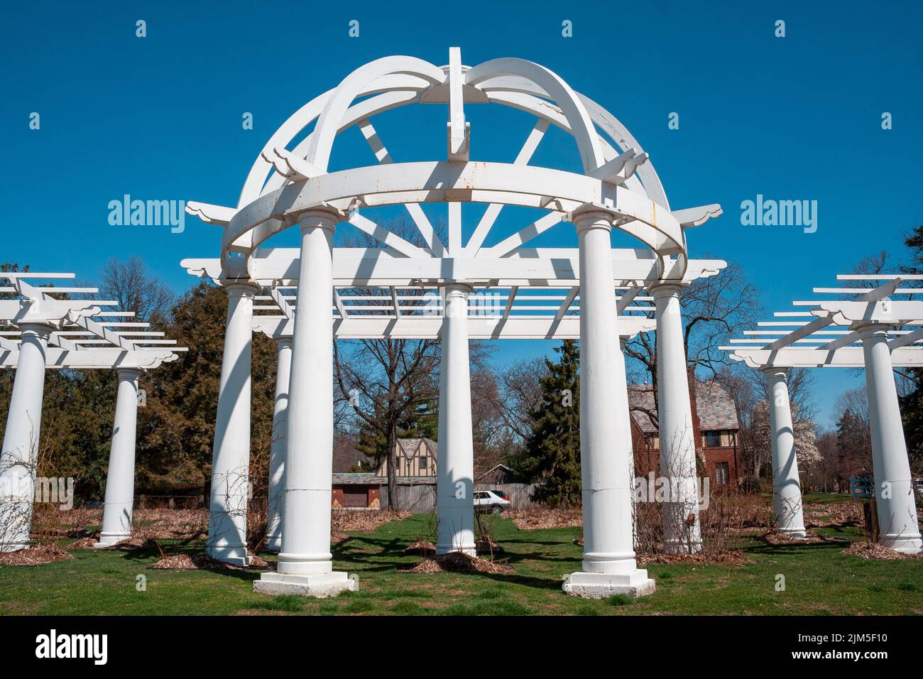 A beautiful shot of a White classic pavilion with columns in the park ...