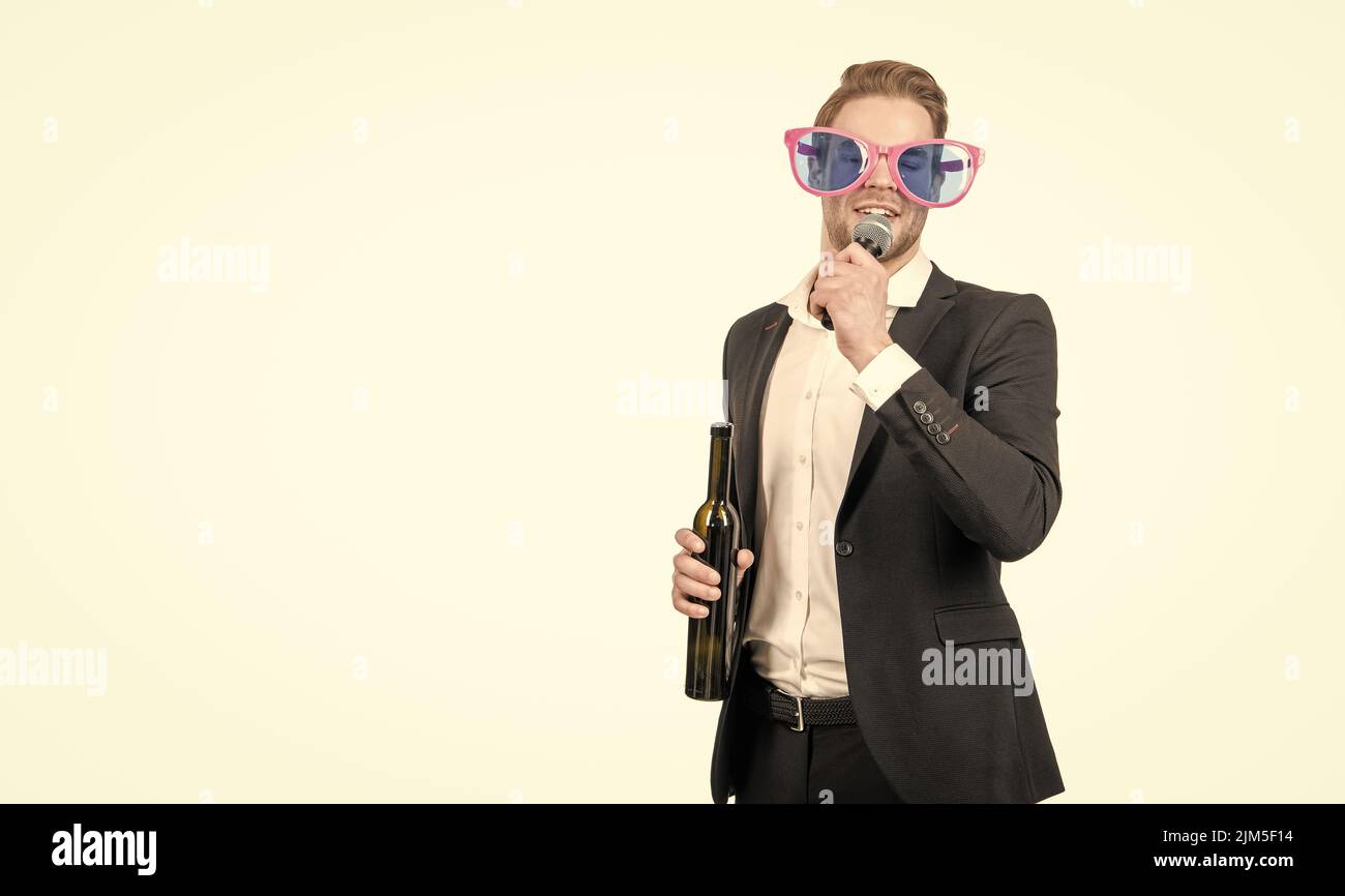 Wine and song. Funny man sing to microphone. Karaoke party. Business ...