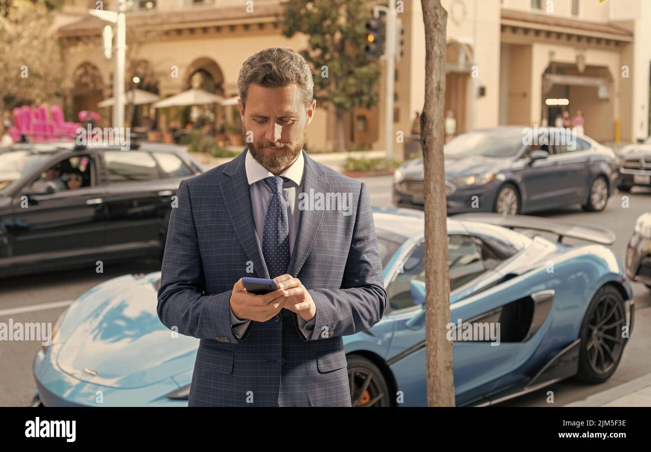 dealer man chat on smartphone next to the car. copy space Stock Photo ...