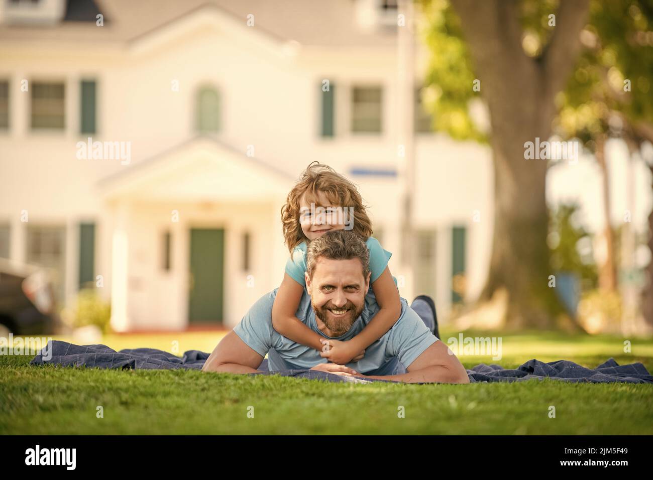 happy father having fun with child relax together on green park grass ...