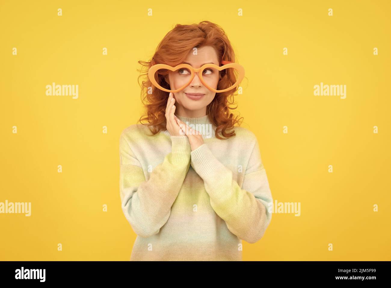 happy redhead woman wear funny party glasses on yellow background ...