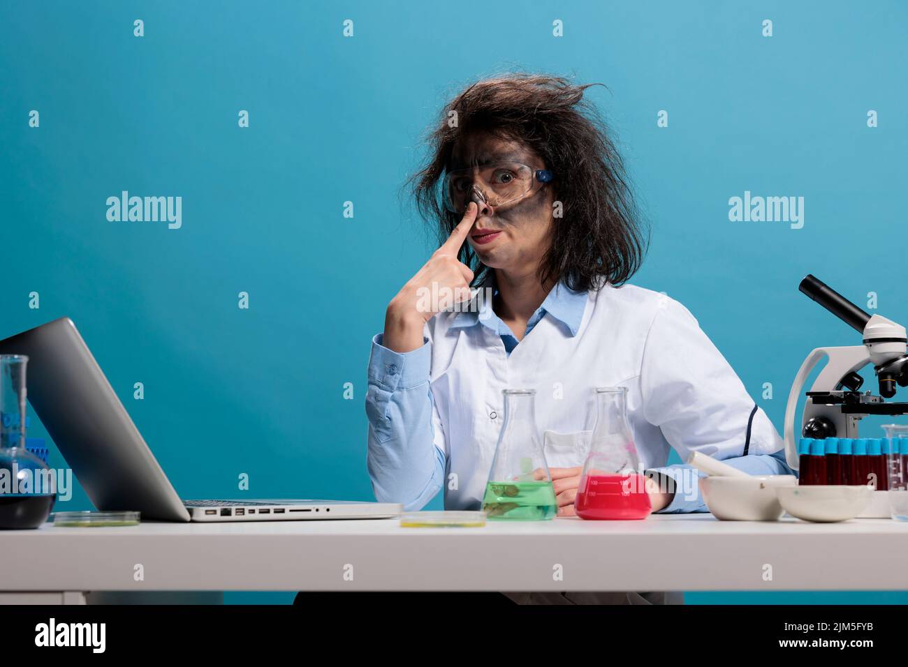 Portrait of crazy amusing chemist acting funny and having dirty face ...