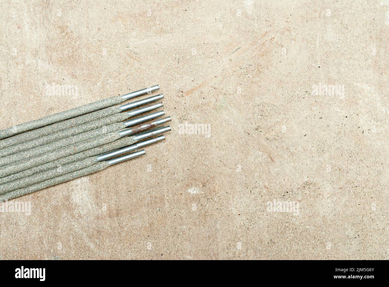 Several welding electrodes on a textured background with space for text ...