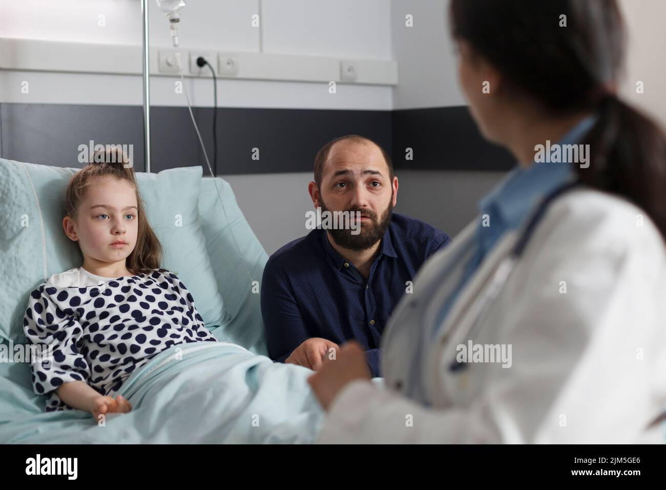 Pediatric expert talking with father of hospitalized sick little girl ...