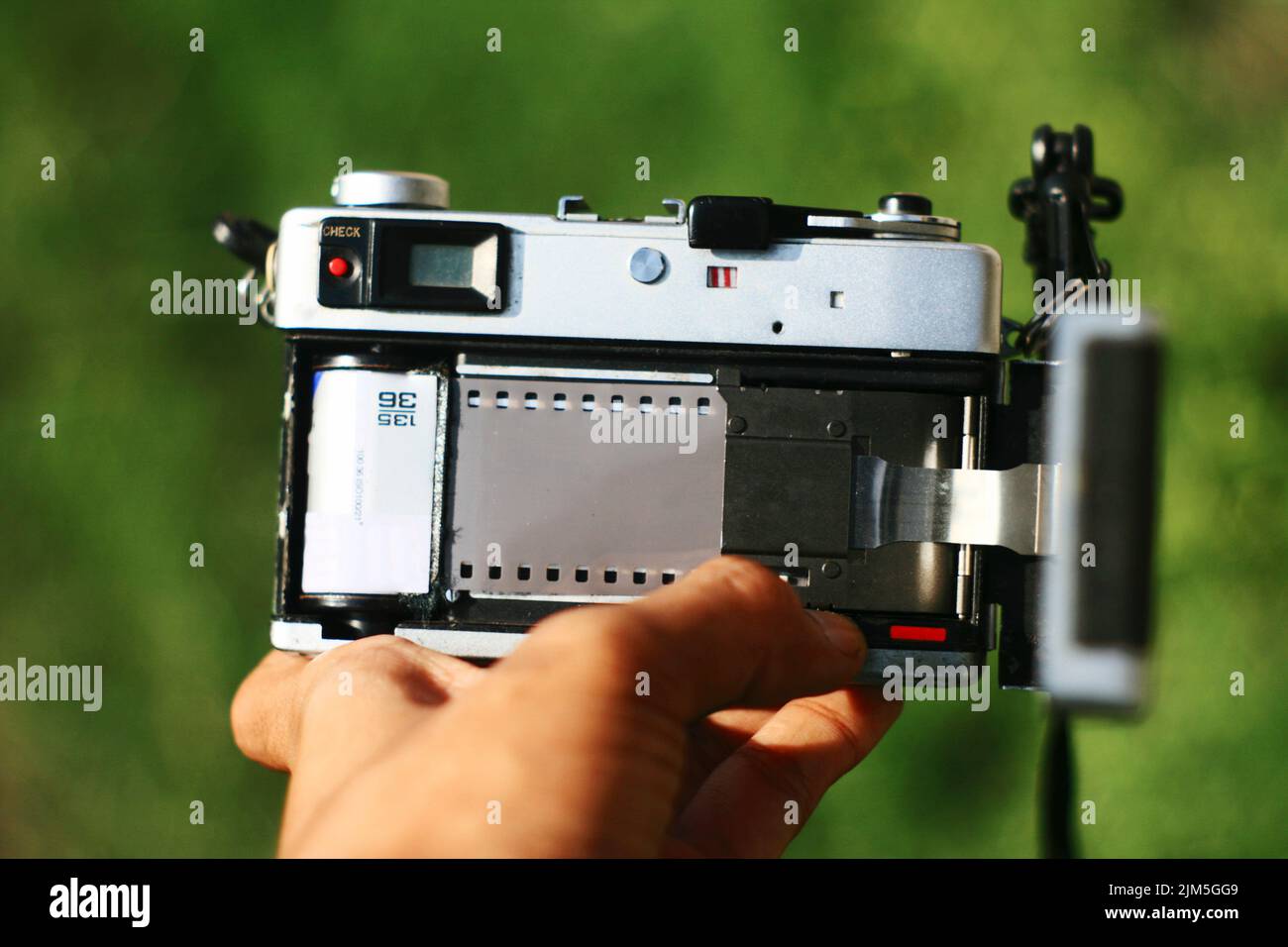 Rear view of classic 35mm analog camera with negative film Stock Photo ...
