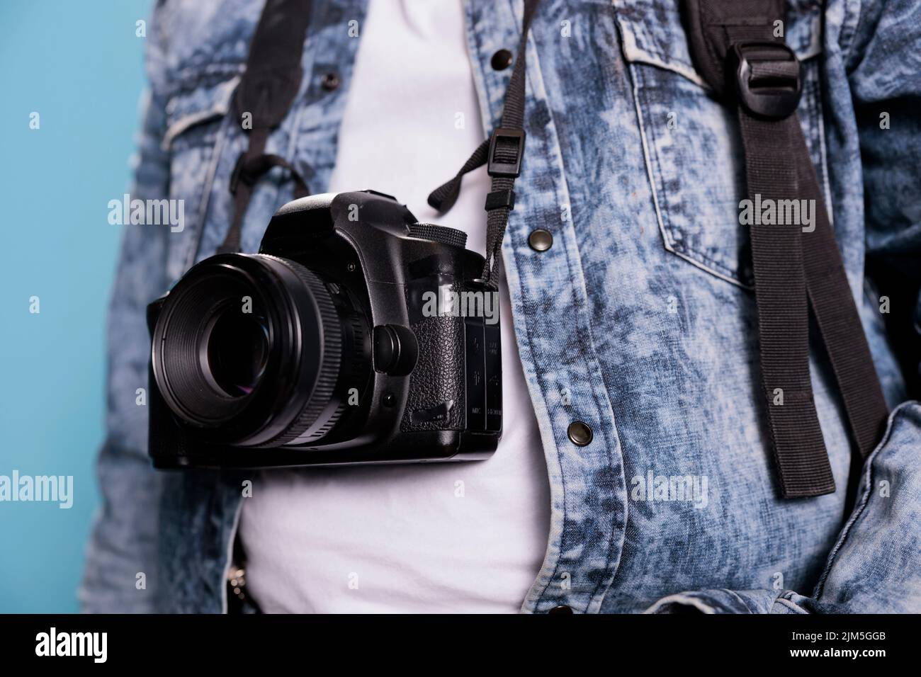 Close up shot of photographer wearing denim jacket and having modern ...